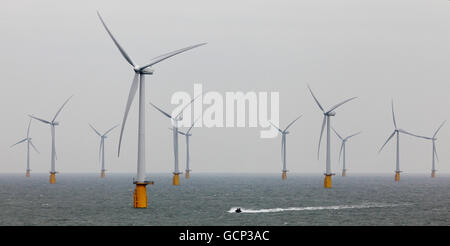 A small boat passes through the windmills of the Thanet Offshore Wind ...