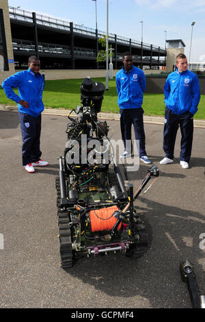Members of the England U21 squad are shown how a mortar works during a ...