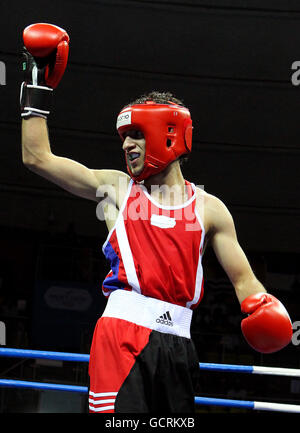 Pakistan's Haroon Kahn (red) in action against Mauritius' Gilbert ...