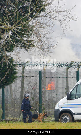 A specialist prison office dog handler patrols outside the perimeter ...