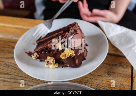Eating chocolate cake while dieting Stock Photo - Alamy