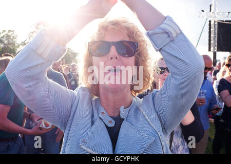 Mature woman cheering at a rock concert in a crowd UK Stock Photo - Alamy