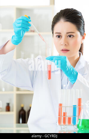 Asian female forensic scientist know knowledge is power in laboratory ...
