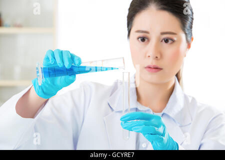 Asian female scientist researcher observing indicator color shift in ...