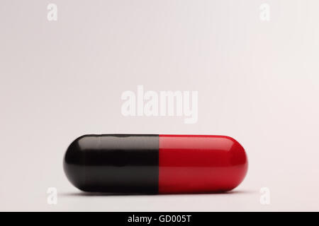 One Red and Black Pill Capsule Isolate on White Background Stock Photo ...