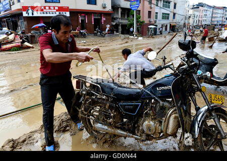 Minqing, China's Fujian Province. 10th July, 2016. Residents clear ...