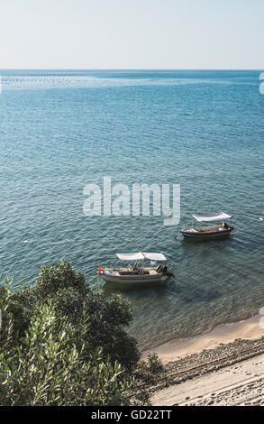 Fishing boats and cages for fish farming Stock Photo - Alamy