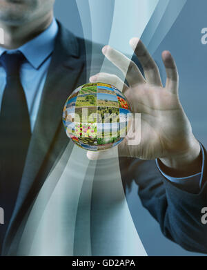 Man holding earth with nature photos Stock Photo - Alamy