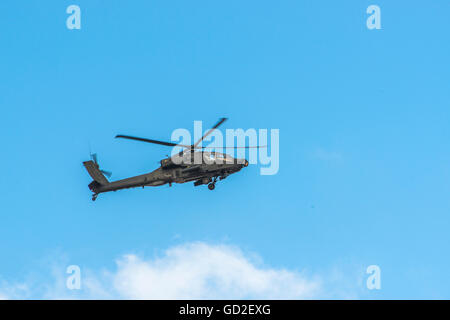 An Apache Helicopter Flying Over Blue Sky Stock Photo - Alamy