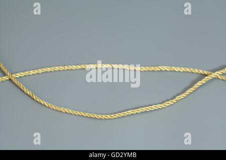 Golden rope isolated on gray background Stock Photo - Alamy
