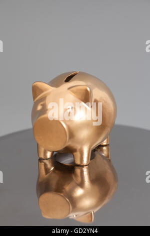 Golden Piggy Bank on gray background Stock Photo - Alamy