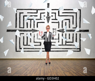 Business woman running with an hourglass. Deadline Stock Photo - Alamy