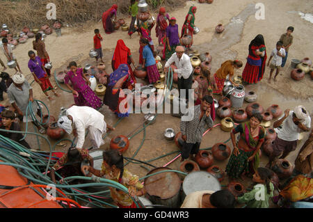 Villagers collecting water from a tanker Stock Photo - Alamy