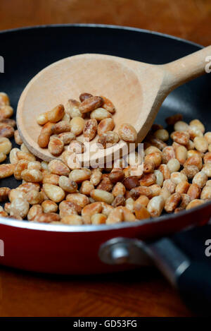 Roasted seeds ( Pinus pinea) in frying pan Stock Photo - Alamy