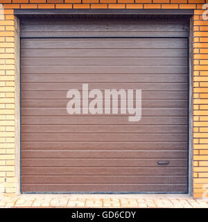 Iron gates on the garage. Brown gates made of steel Stock Photo - Alamy