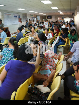 Crowd of people sitting and waiting to examine health, sick patient sit ...