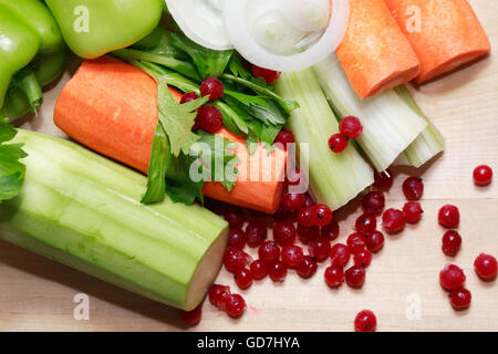 Set of raw vegetables and frozen cranberry on wooden board Stock Photo ...