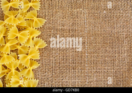 Pasta Bows on Brown Background Stock Photo - Alamy