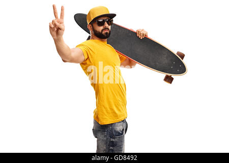 Fashionable man gesturing on skateboard by railing Stock Photo - Alamy