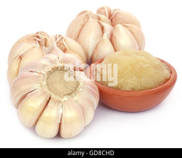 Crushed garlic with whole ones over white background Stock Photo - Alamy