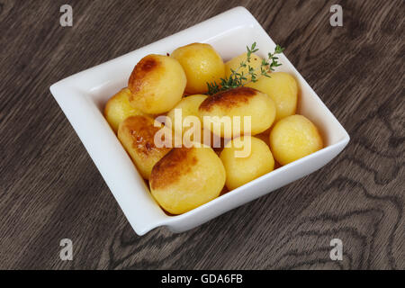 Golden backed potato with thyme branch Stock Photo - Alamy