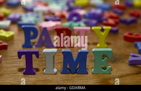party time - words made from multicolored letters on wooden background ...