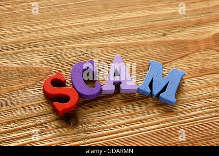 SCAM - words made from multicolored letters on wooden background Stock ...