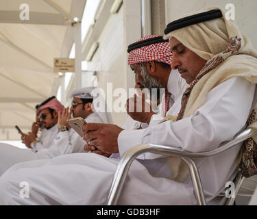 Officials of the Al Galayel Hunting Festival in Qatar relax in their ...