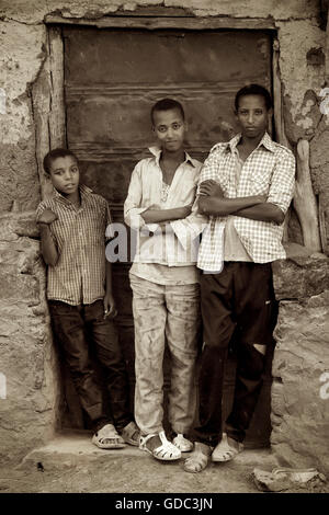 Ethiopian boys sheltering from the rain outside a shop. Addi Arkay ...