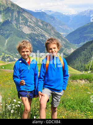 Two brothers in green grass field Stock Photo - Alamy