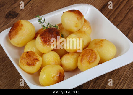 Golden backed potato with thyme branch Stock Photo - Alamy