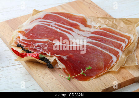 Jamon serrano with pepper and thyme leaves Stock Photo - Alamy