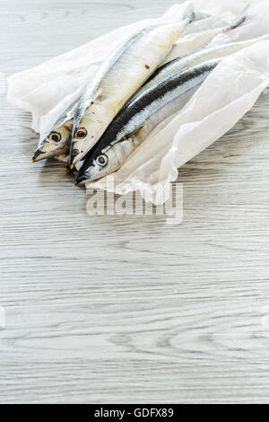 saury fish on the wooden board Stock Photo - Alamy