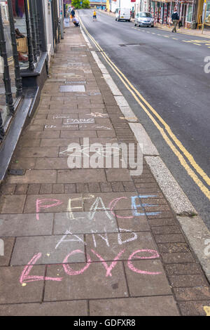 The words "Be Happy" written with sidewalk chalk, inside a rainbow, on ...