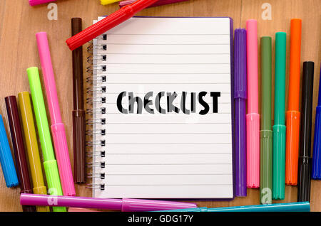 Checklist written on whiteboard over wooden background Stock Photo - Alamy