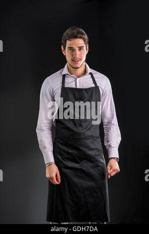 Black man wearing an apron and cooking in action. Mixed media Stock ...