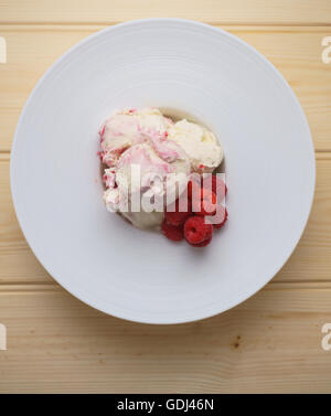 Raspberry ripple ice cream, served with fresh raspberries Stock Photo ...