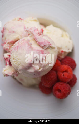 Raspberry ripple ice cream, served with fresh raspberries Stock Photo ...