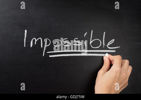 Impossible text on school board and chalk Stock Photo - Alamy