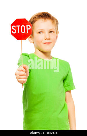 Schoolboy holding a stop traffic sign and crossing at a pedestrian ...