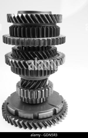Steel cogs together on plain background Stock Photo - Alamy