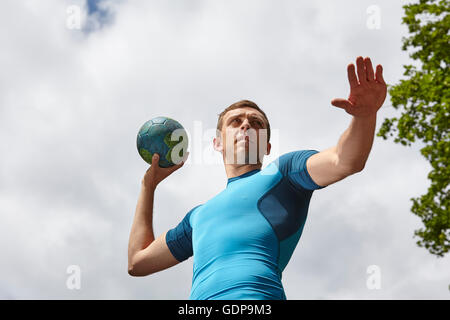 Young male handball player preparing to throw ball Stock Photo - Alamy