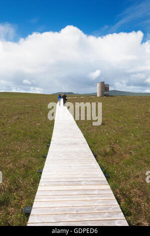 Visitors walking towards the viewing tower at Forsinard RSPB reserve ...