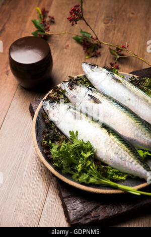 Fresh Uncooked Gizzard Fish with Lettuce and Herbs on Straw Tray Stock ...