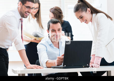 Business team reporting to boss having meeting in office discussing ...