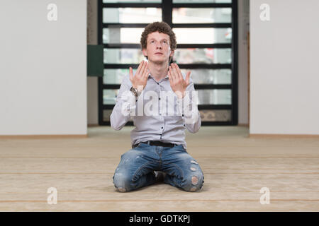 Humble White Muslim Man Is Praying In The Mosque - Afro Lock Hair Curly ...