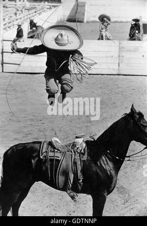 A young Mexican charro practices with his lasso as he stands on his ...