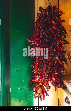 Red and green chillies hanging on a tree Stock Photo - Alamy