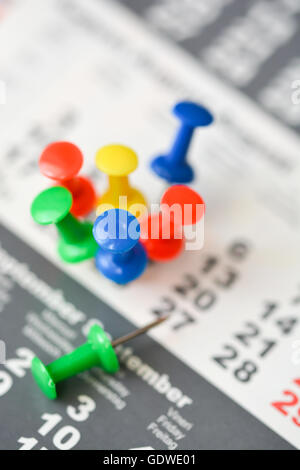 busy schedule - colorful pins on a calendar Stock Photo - Alamy