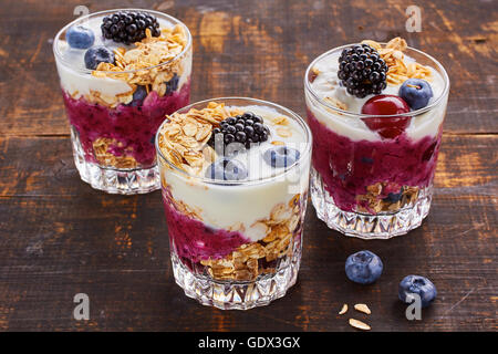 Tree yogurt desserts with berries and muesli Stock Photo - Alamy
